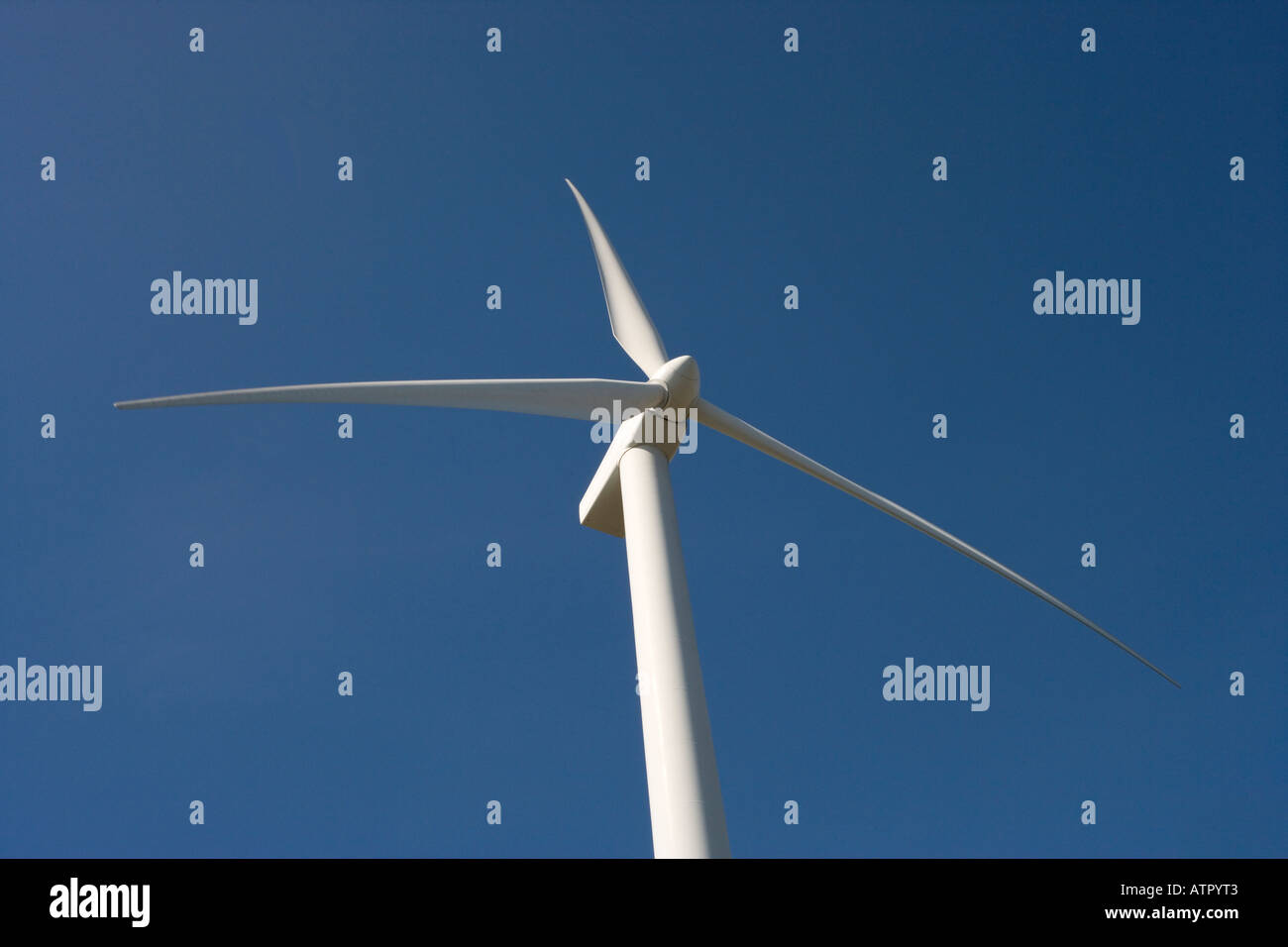 white wind turbine against blue sky Stock Photo - Alamy