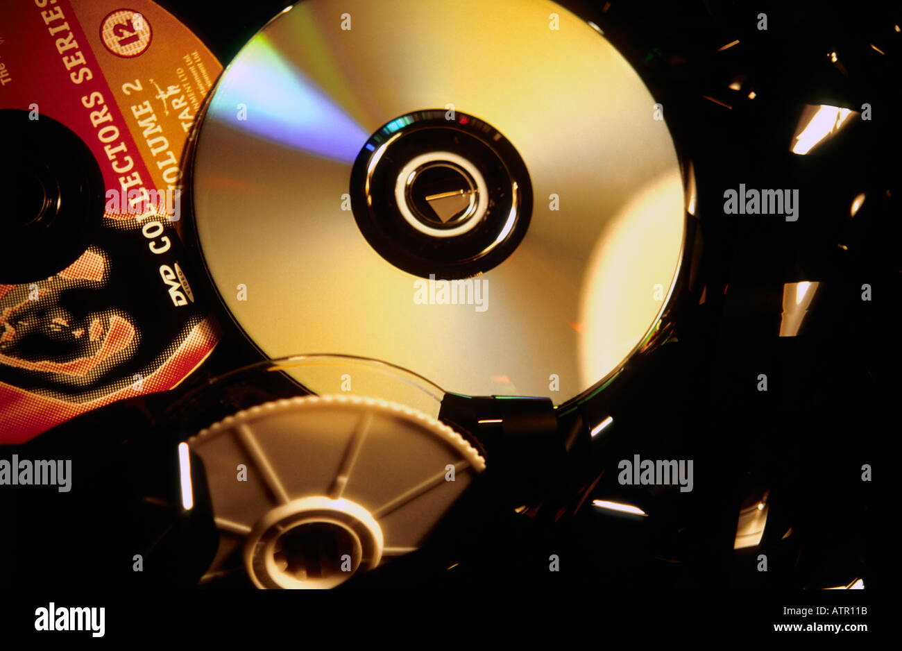 dvd discs lying on rolls of video tape Stock Photo - Alamy