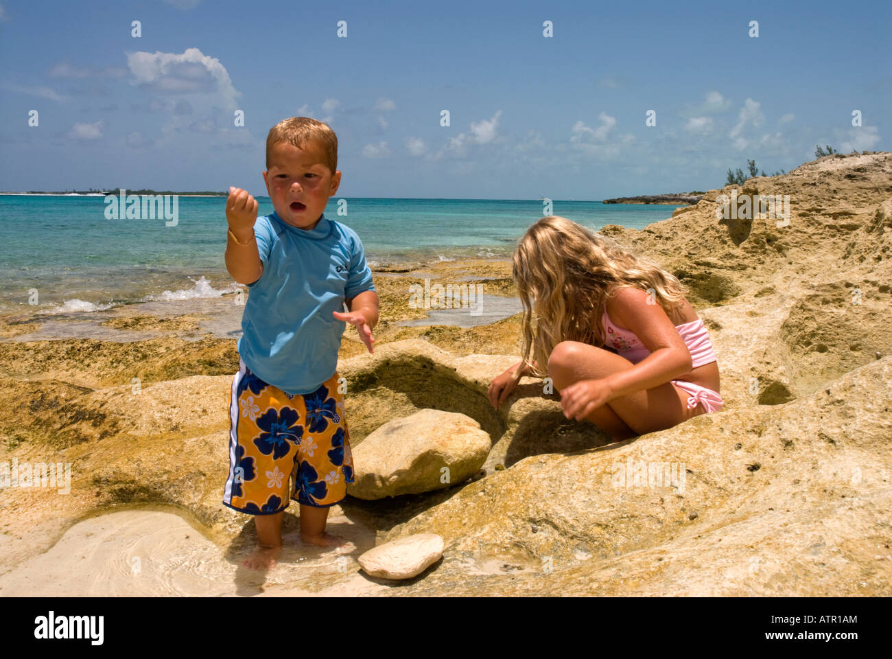 Children playing on rocks, Rose Island, Bahamas Stock Photo - Alamy