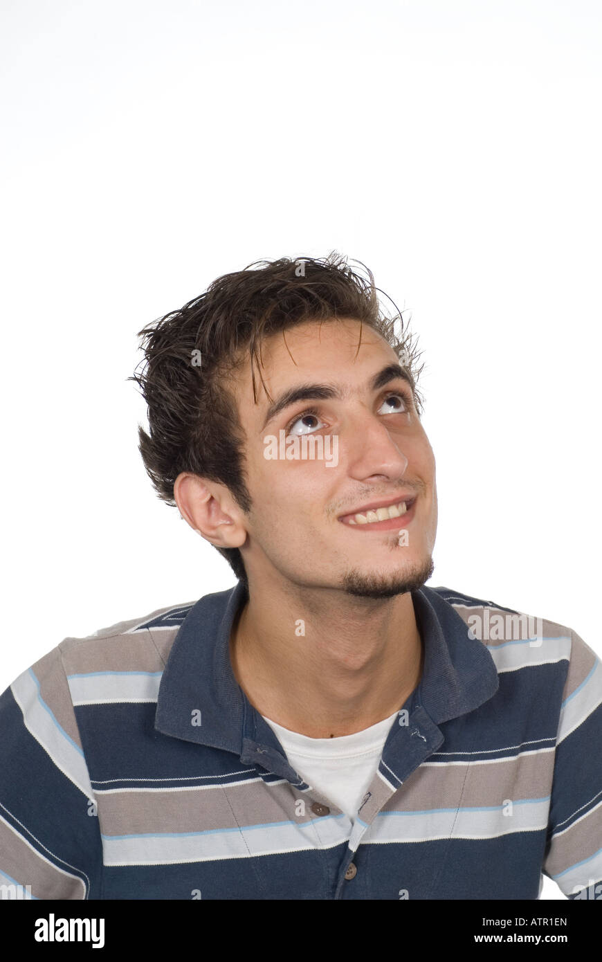 Happy teenager looking up smiling on a white background Stock Photo - Alamy