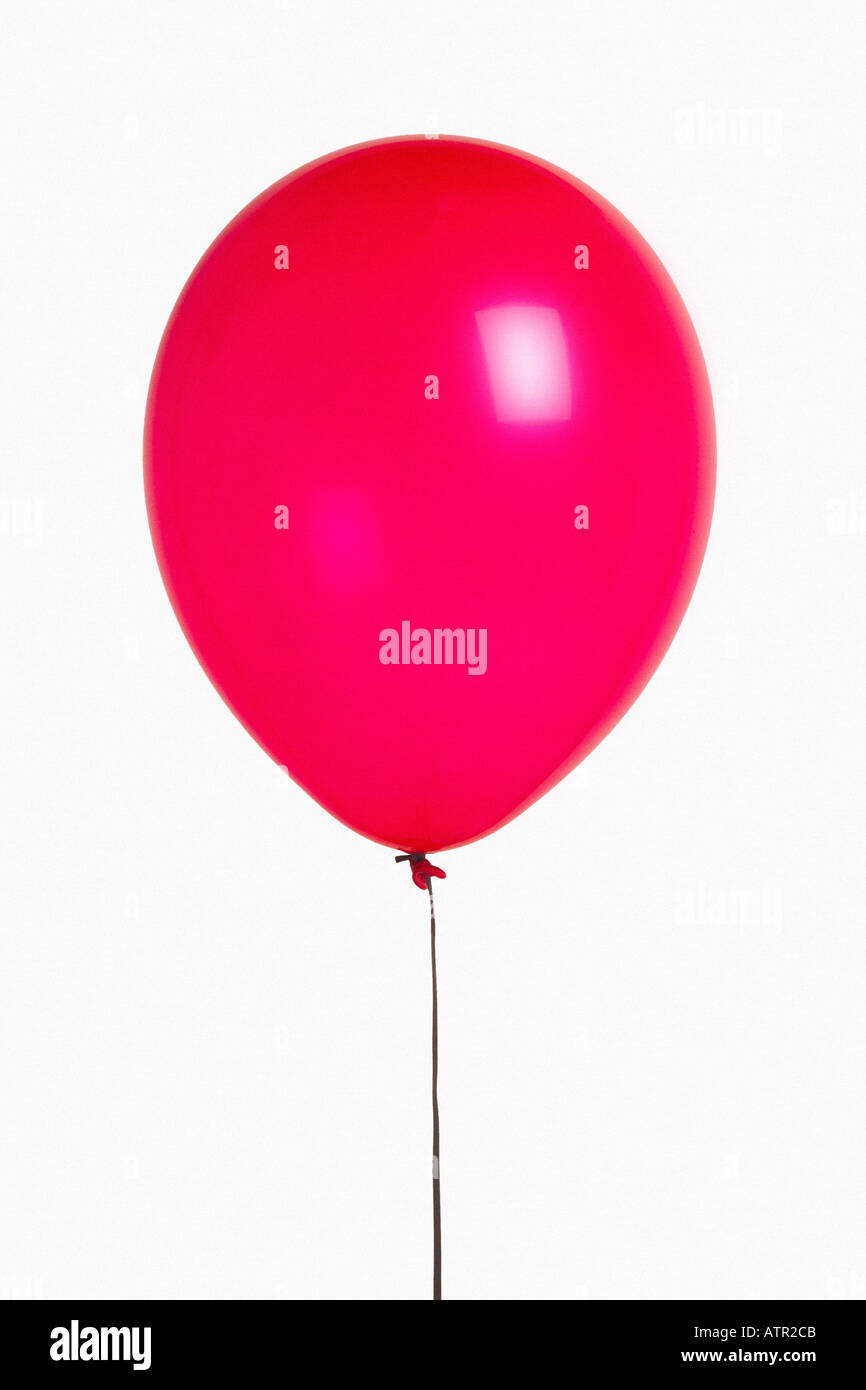 Single red helium balloon on black ribbon against white background ...