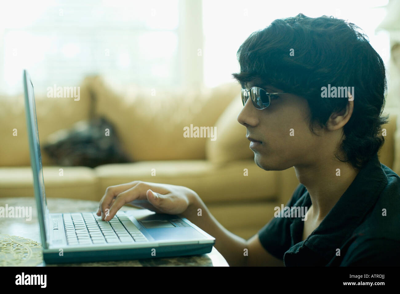 Close-up of a teenage boy using a laptop Stock Photo - Alamy