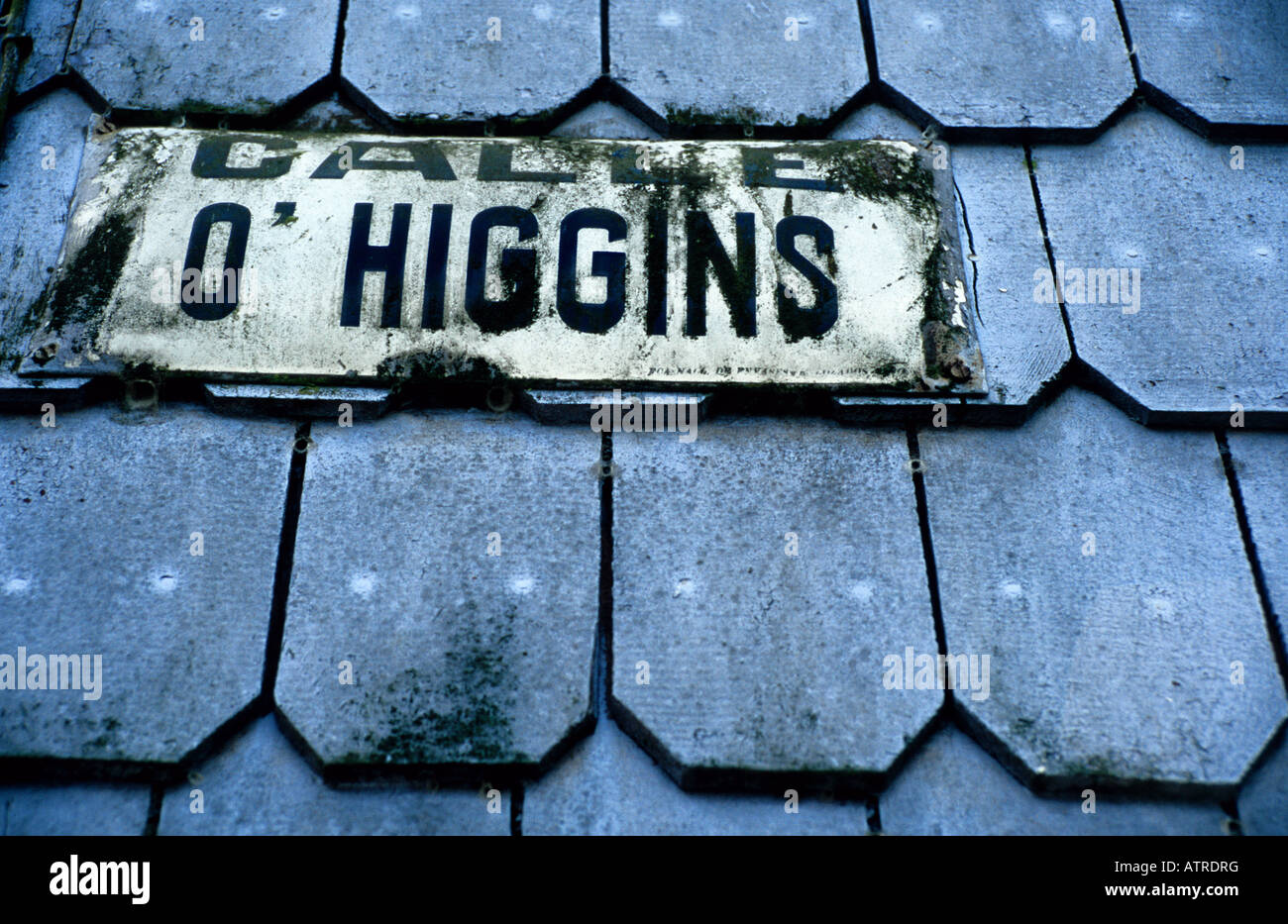 Calle O'Higgins street sign on an old wooden tiled house, Chiloe ...