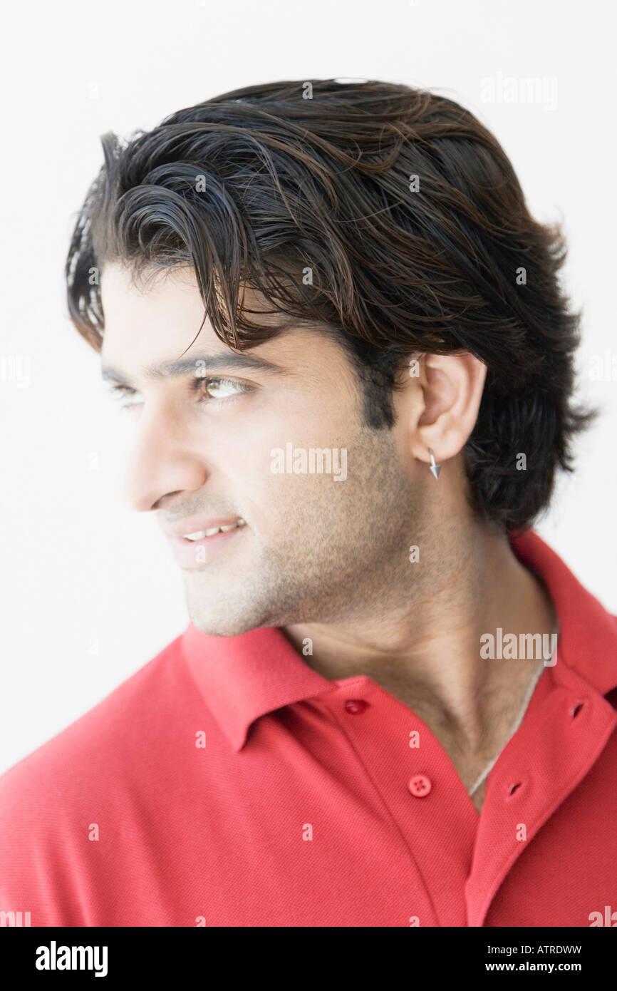 Close-up of a young man looking sideways and smiling Stock Photo - Alamy