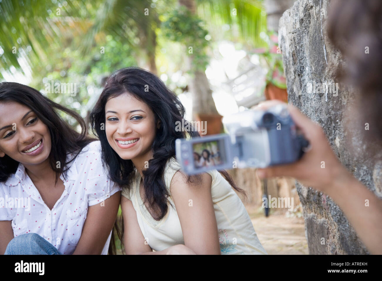 Person's hand filming two young women with a digital video camera Stock ...