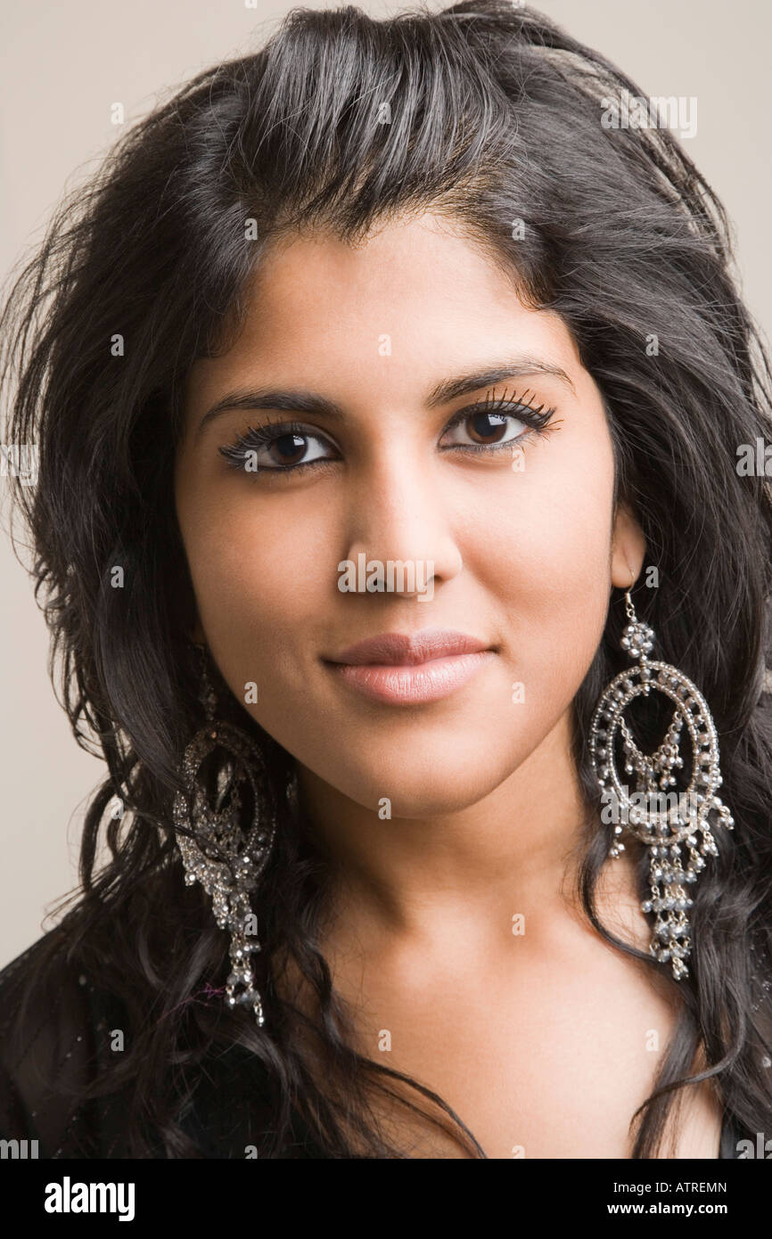 Portrait of a young woman smirking Stock Photo - Alamy