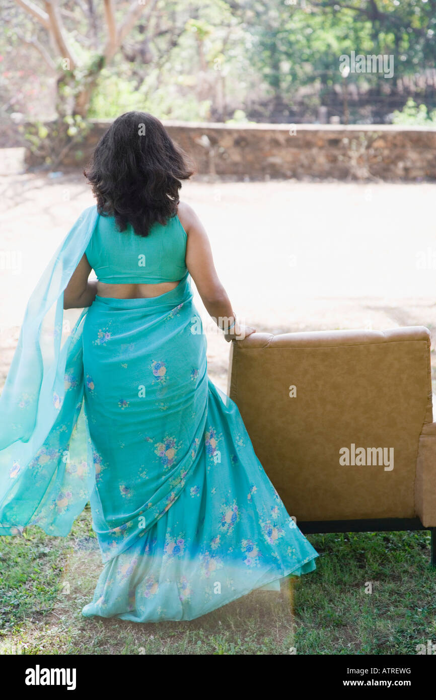Rear view of a mature woman standing at the roadside Stock Photo - Alamy