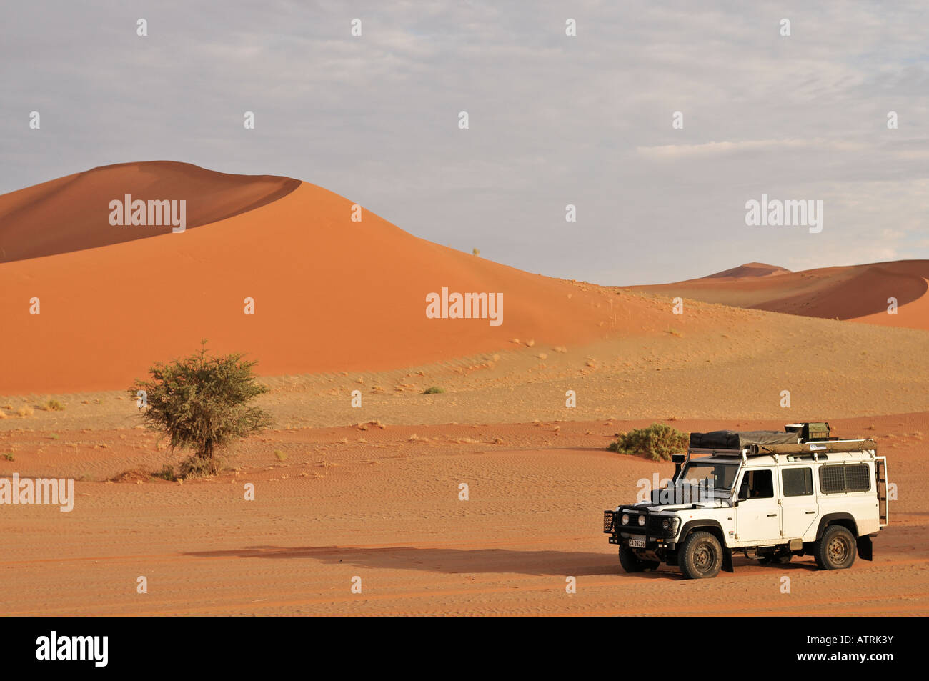 Land Rover travelling through the Sousouvlei Dunes early in the African ...