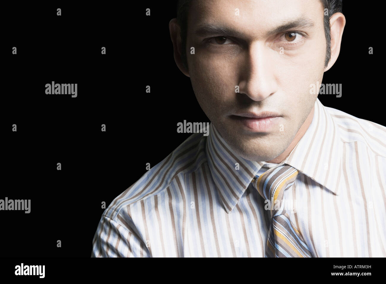 Portrait of a businessman looking serious Stock Photo - Alamy