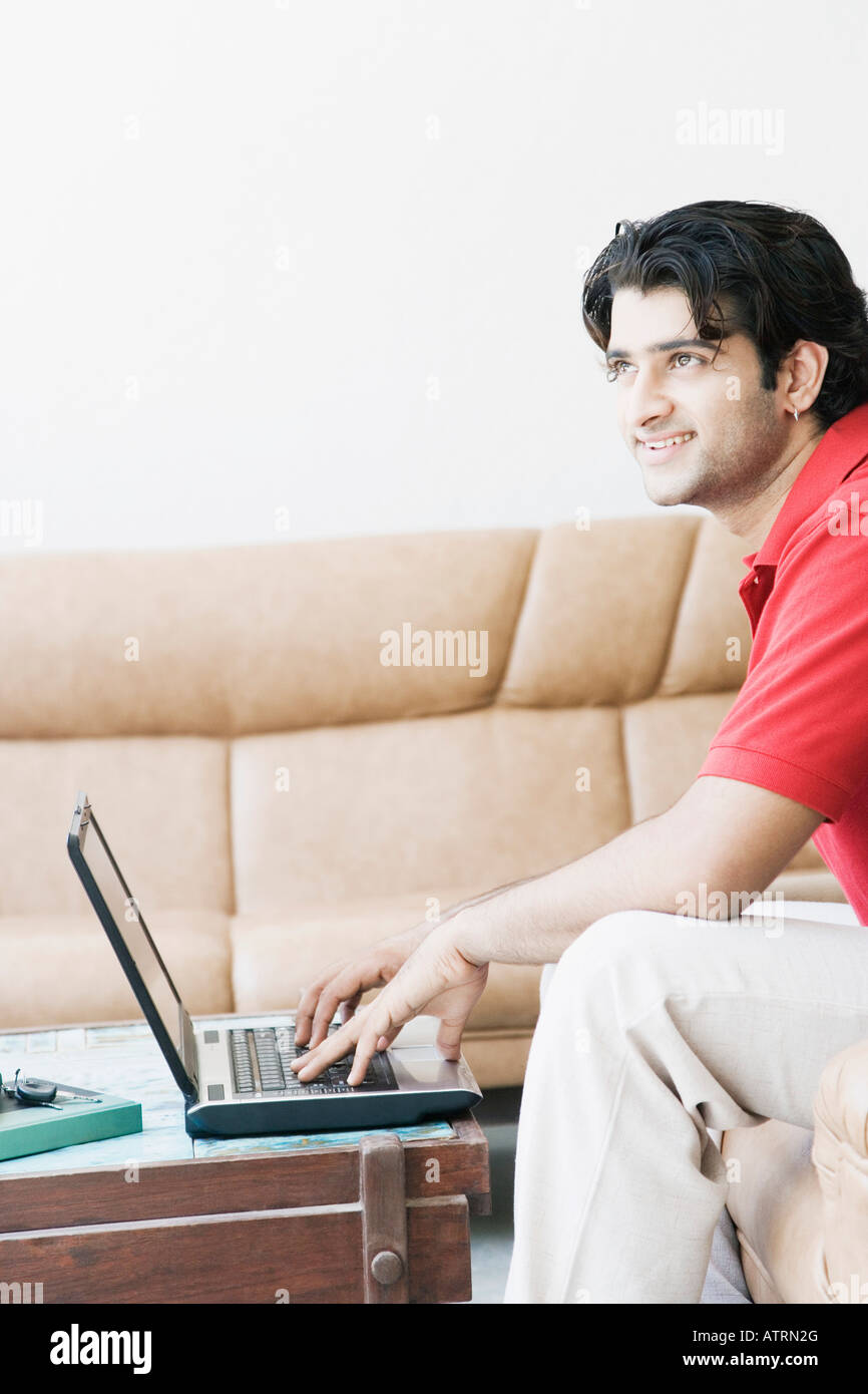 Side profile of a young man using a laptop Stock Photo - Alamy