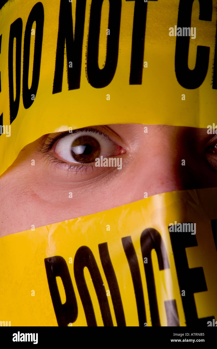 Close up of human eye staring from under POLICE crime scene tape Stock ...