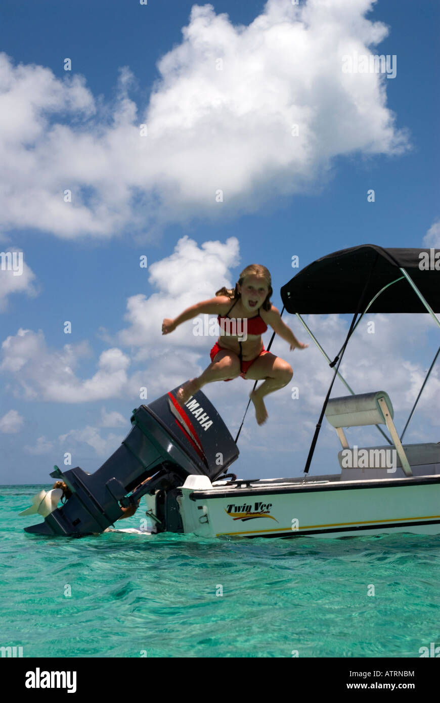 Girl jumping off of boat Rose Island Bahamas Stock Photo - Alamy