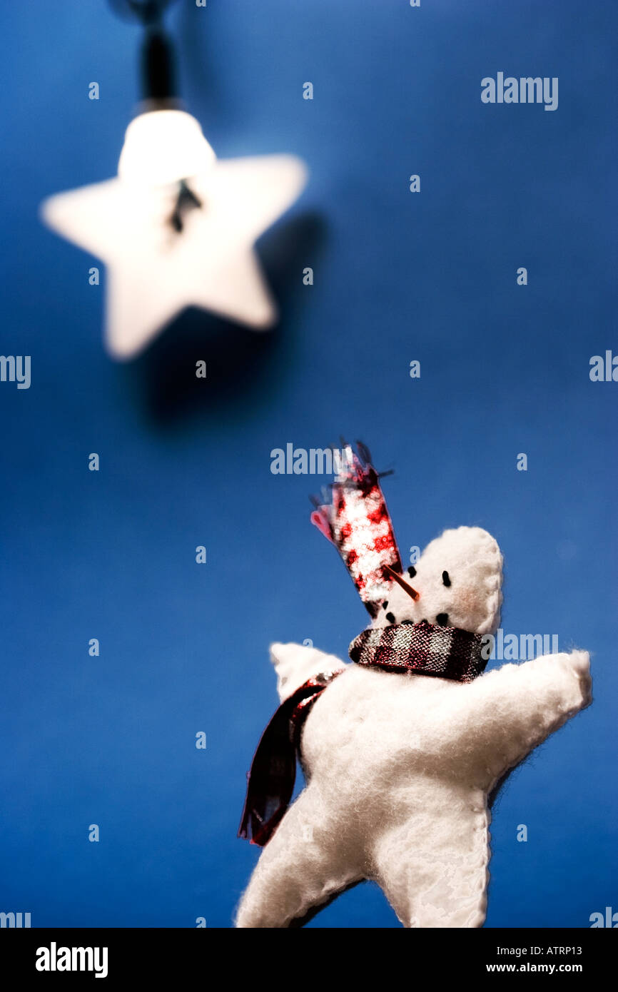 Toy snowman looking up at snowman christmas light Stock Photo - Alamy