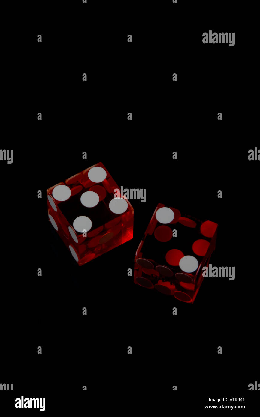 Red dice on black background showing seven 7 Stock Photo - Alamy