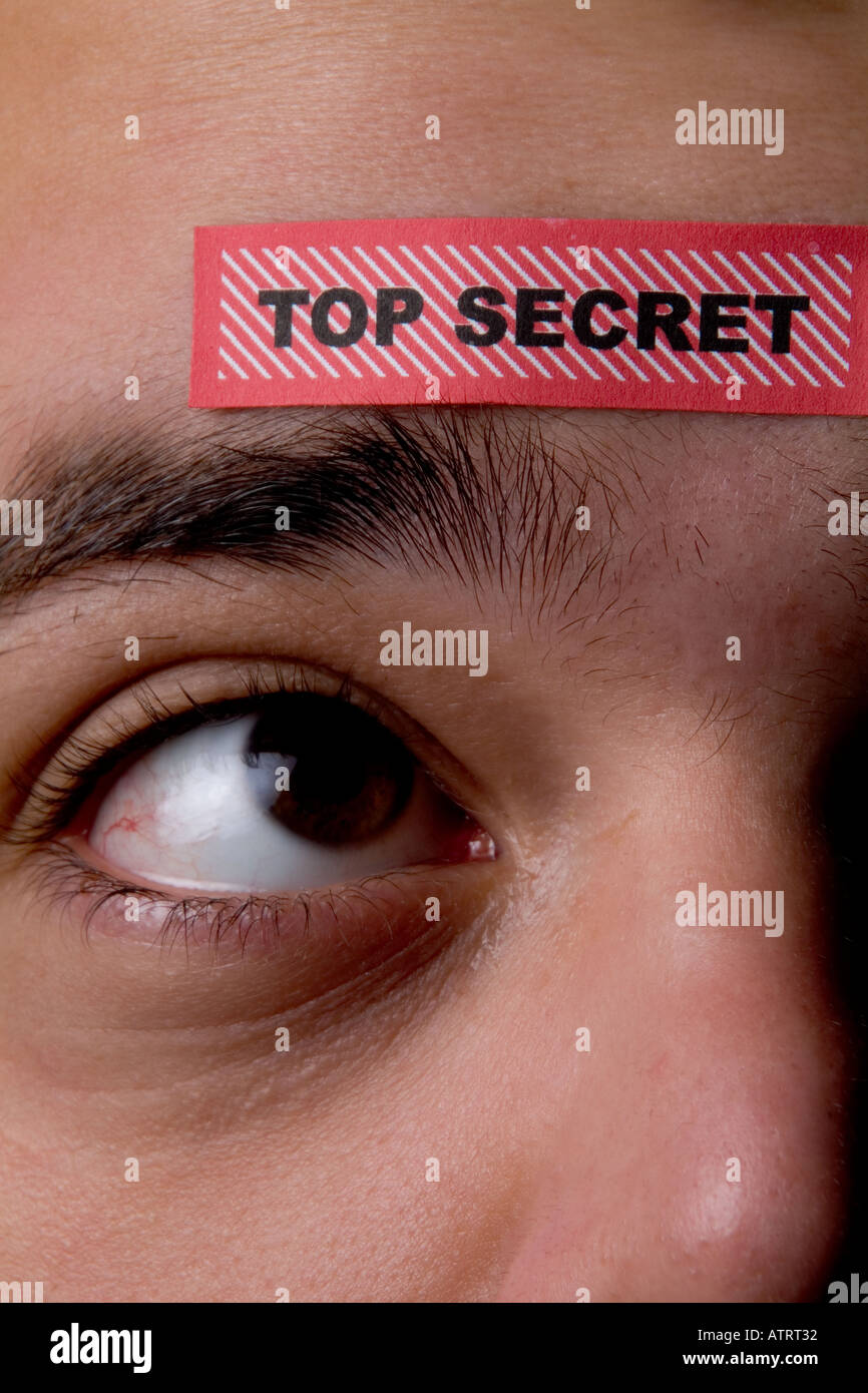 Close up of human eye staring at TOP SECRET label Stock Photo - Alamy