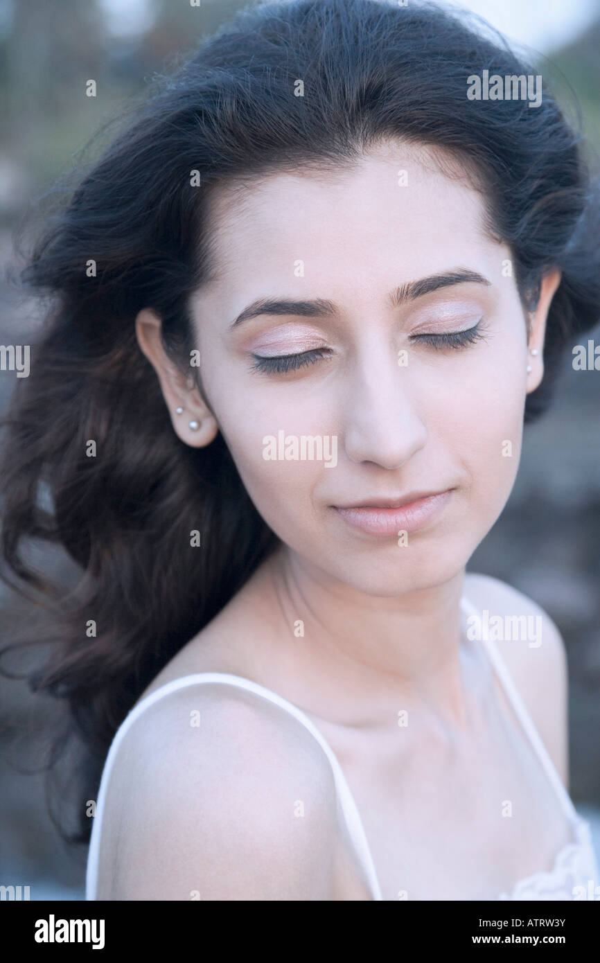 Close-up of a young woman thinking with her eyes closed Stock Photo - Alamy