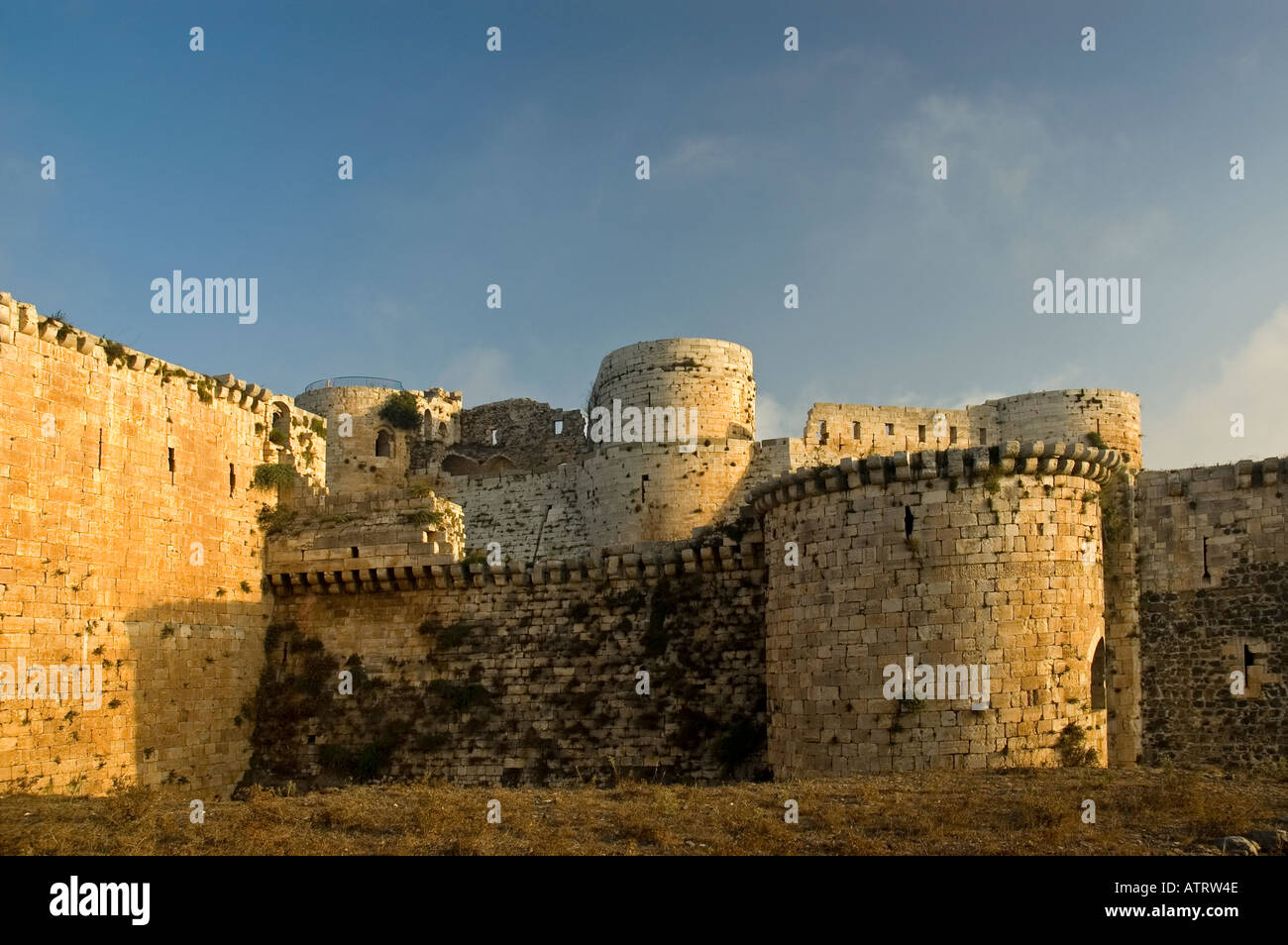 Massive towering walls and ramparts in the early morning sunlight, Crac ...