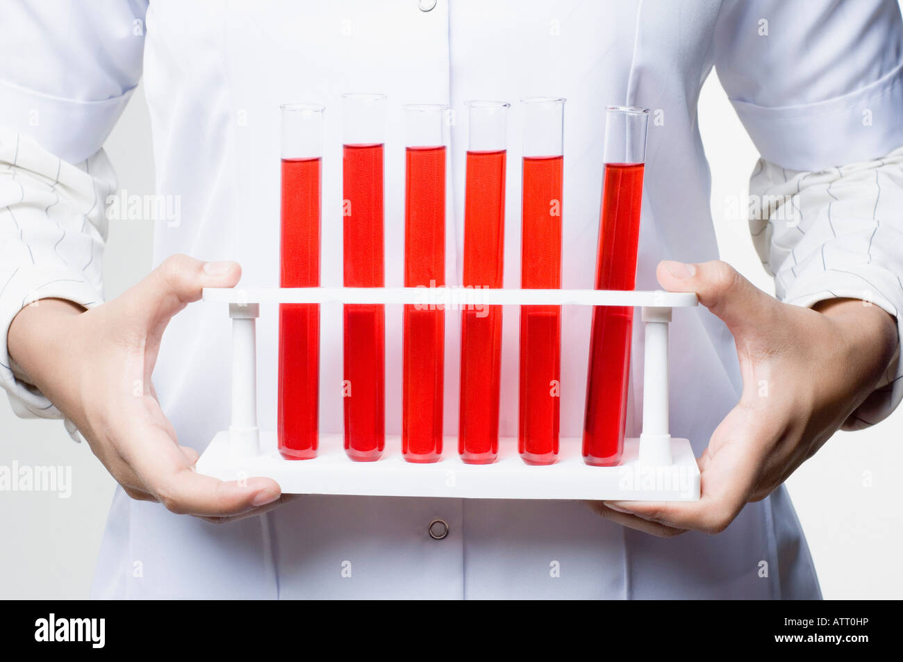 Technician holding and examining test tubes hi-res stock photography ...