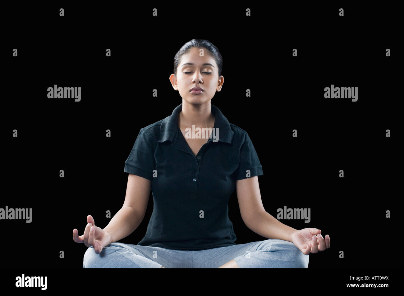 Young woman meditating in a lotus position Stock Photo - Alamy
