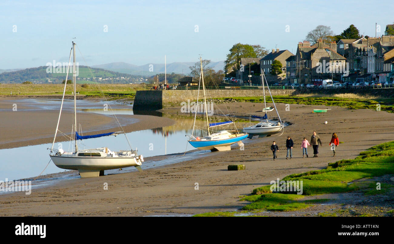 Family walking along the sandy beach at Arnside, Cumbria UK, the ...