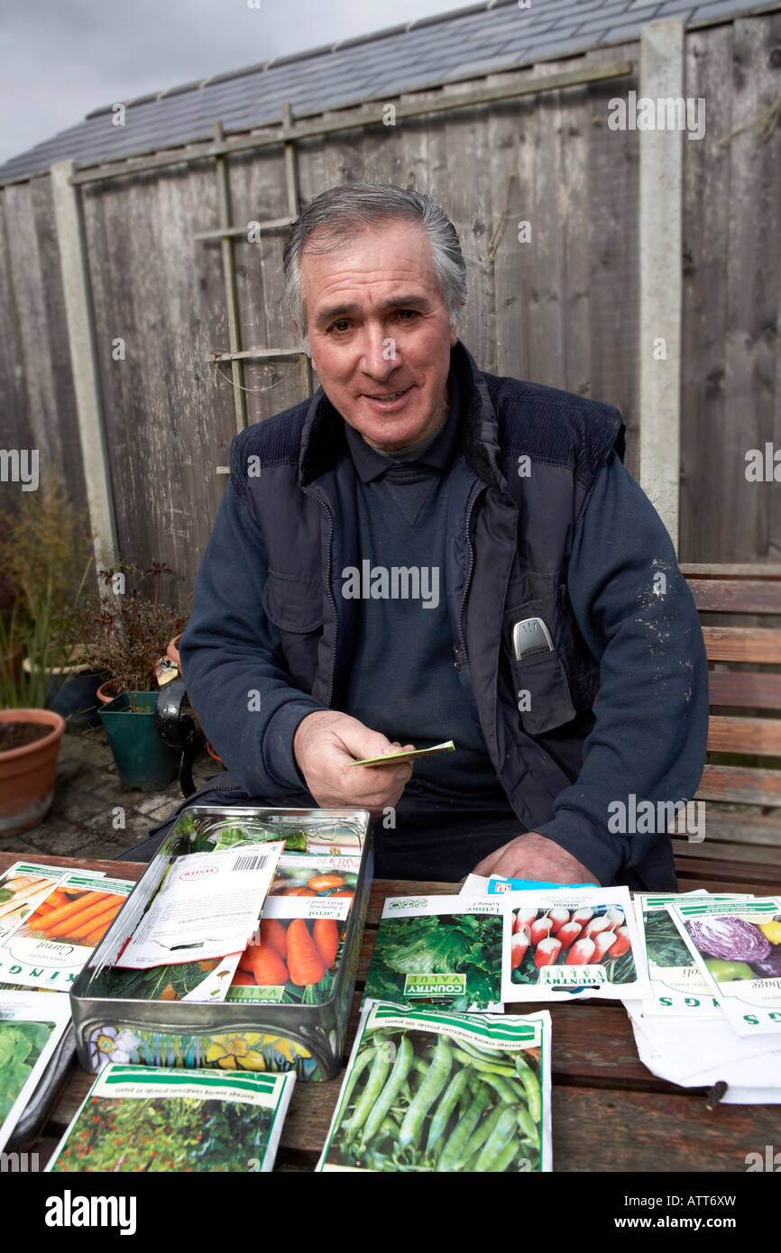Portrait of Retired Man 65 70 years sorting plant and vegetable seeds ...