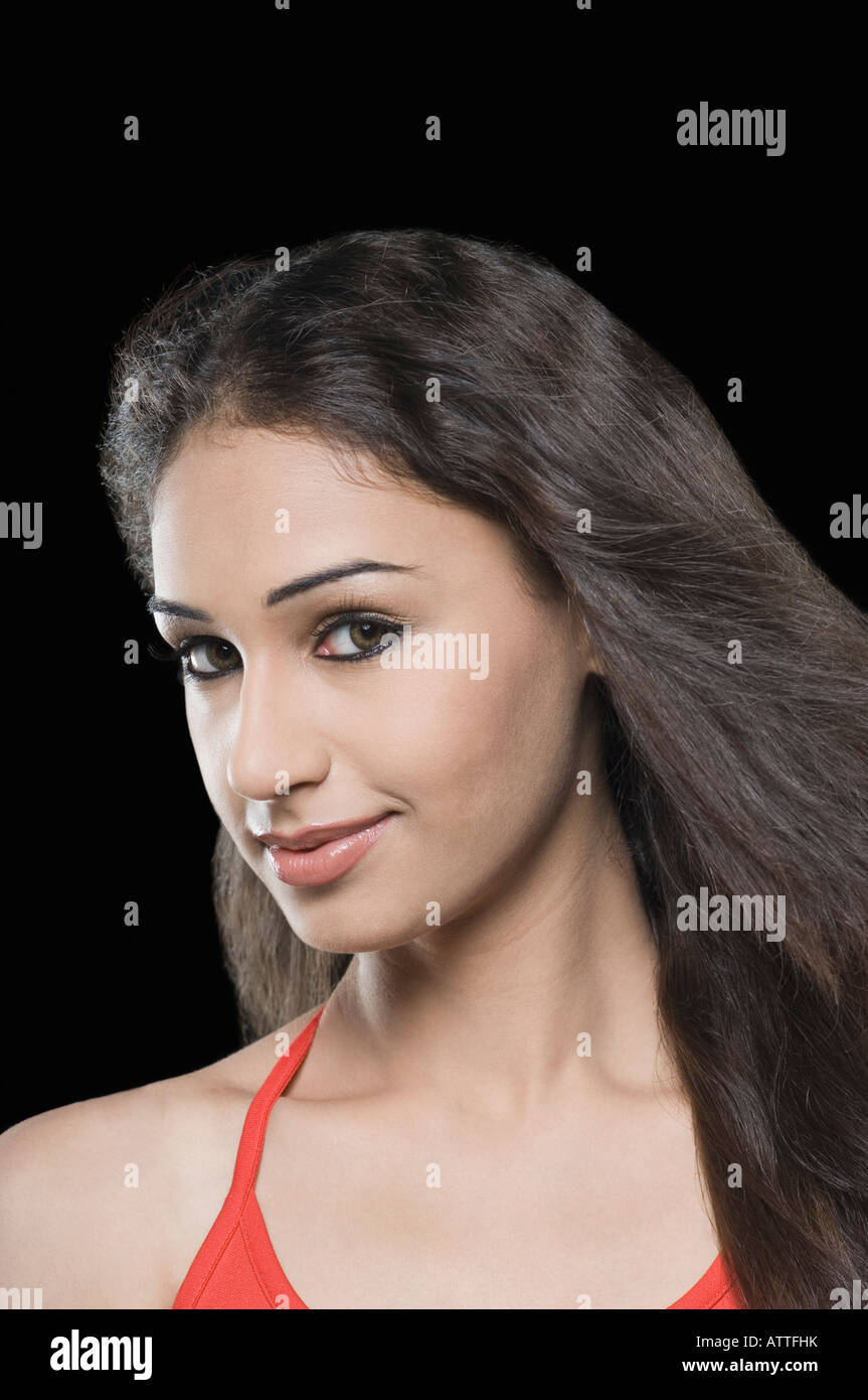 Portrait of a young woman smirking Stock Photo - Alamy