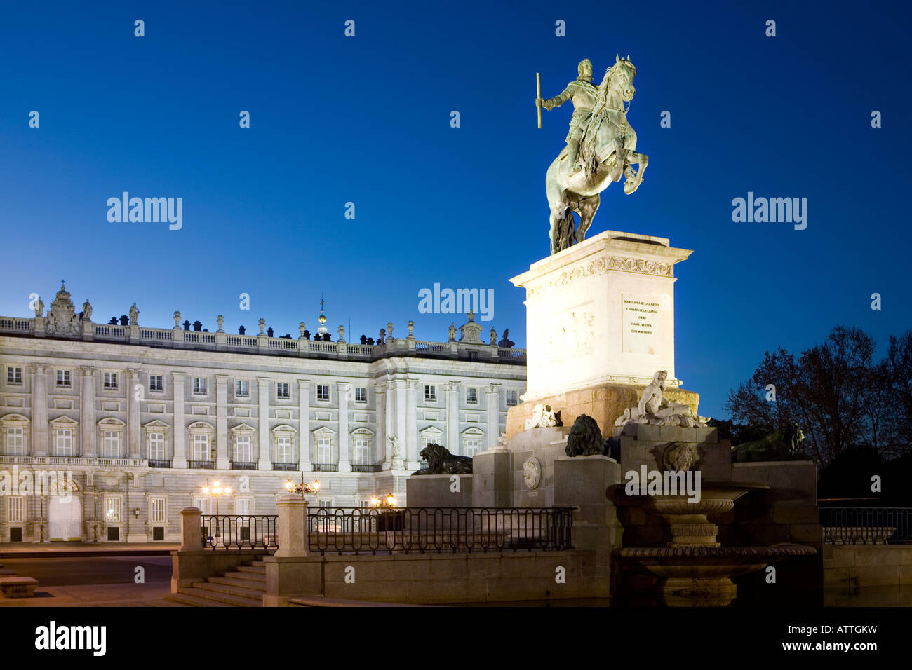 Palacio Real and Statue Felipe IV at Plaza de Oriente in Madrid at dusk ...