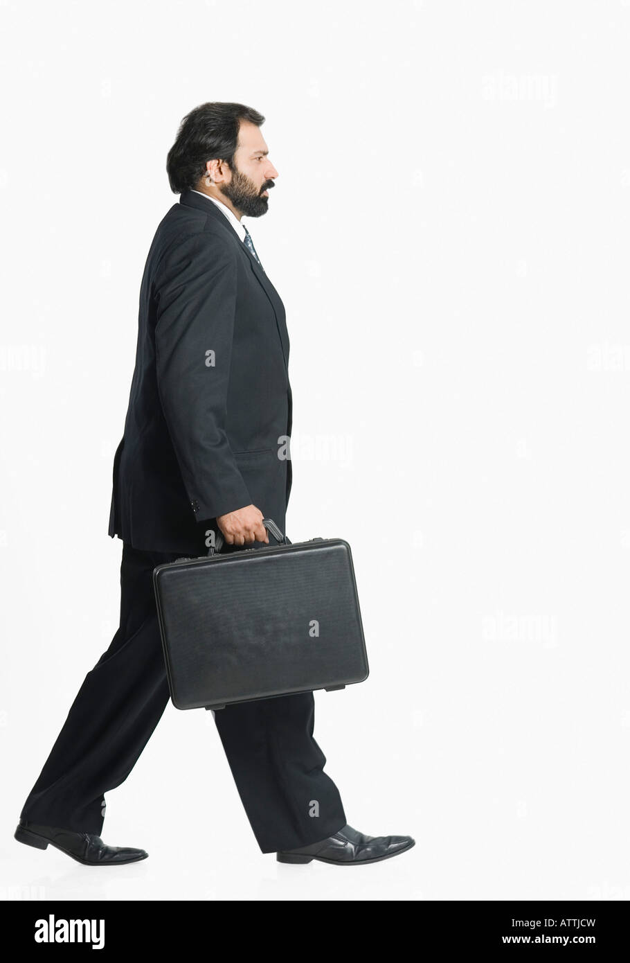 Side profile of a businessman carrying a briefcase Stock Photo - Alamy