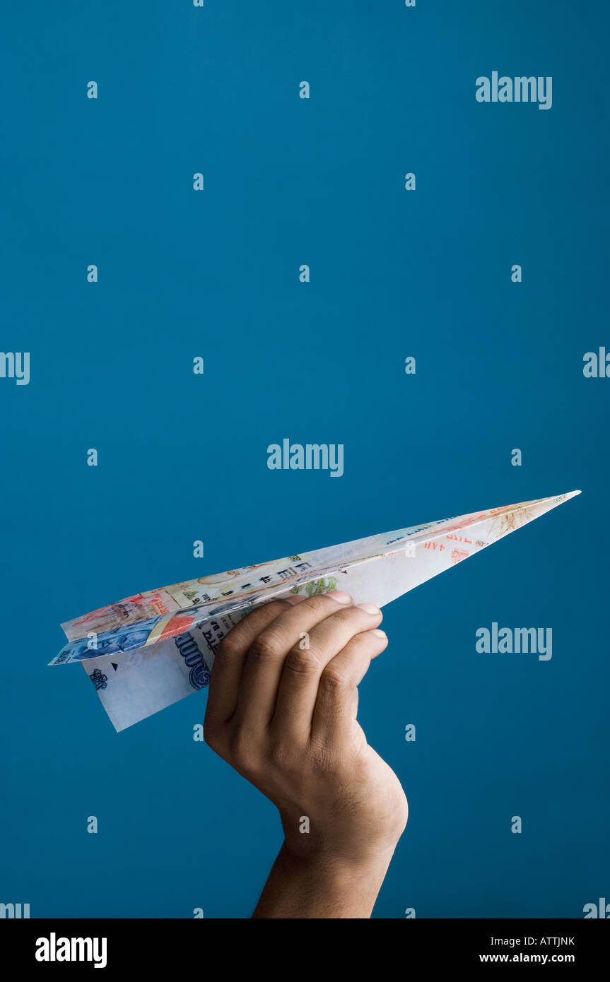 Close-up of a person's hand flying a paper airplane Stock Photo - Alamy