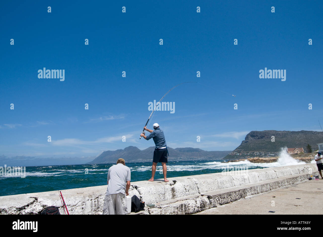 Fish Hoek harbour with people fishing on the False Bay coast of Cape ...