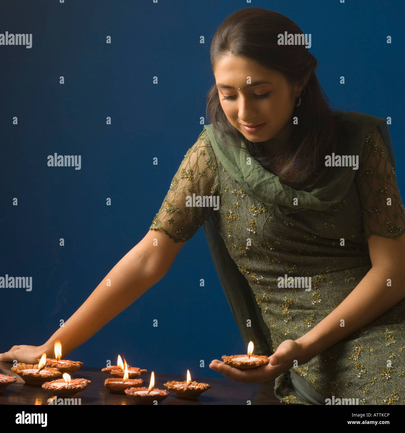 Woman lighting diya hi-res stock photography and images - Alamy