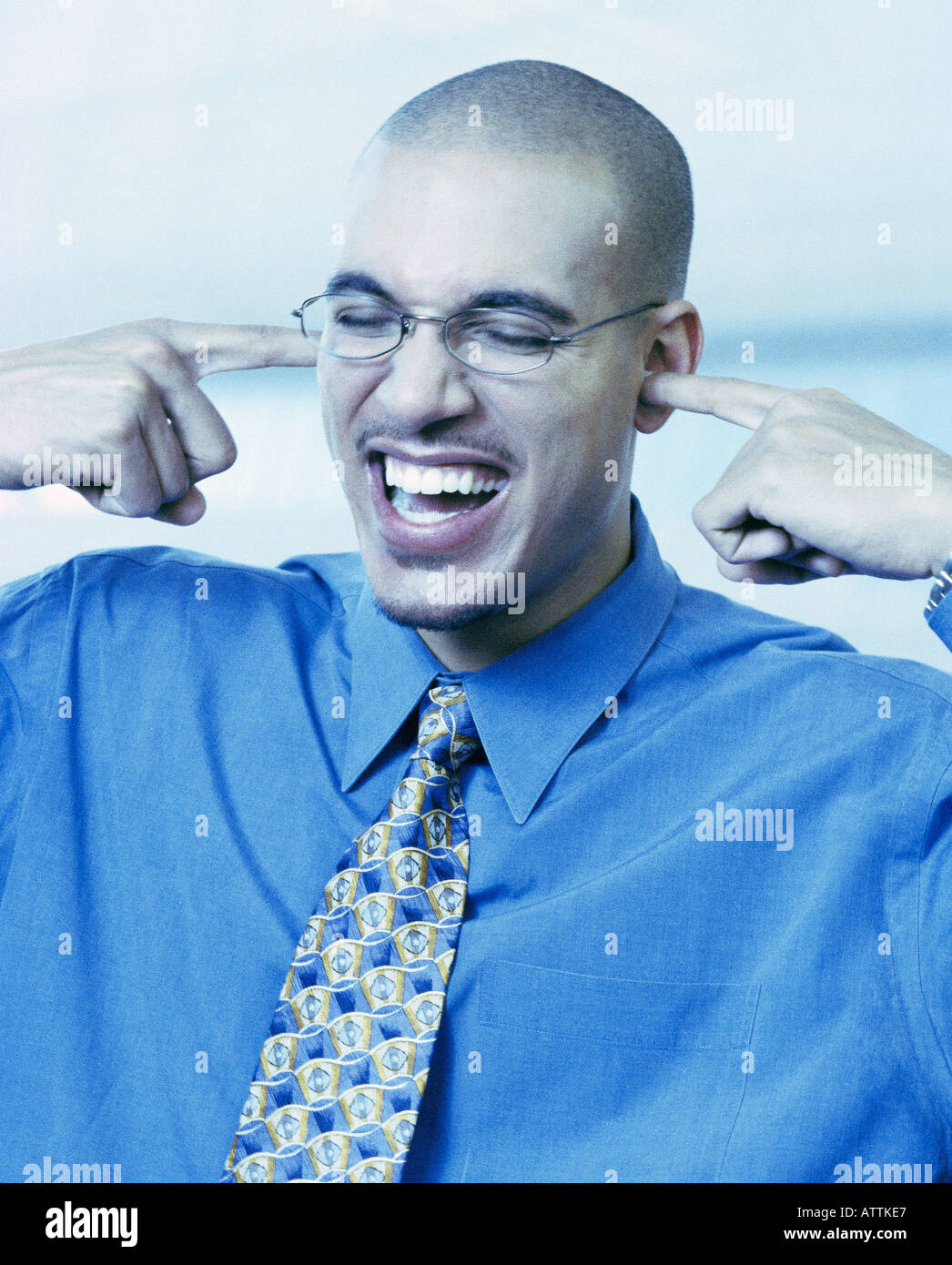 Close up of man plugging his ears with fingers Stock Photo - Alamy