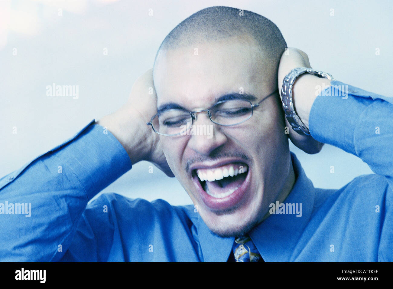 Closeup of man screaming and covering his ears Stock Photo - Alamy