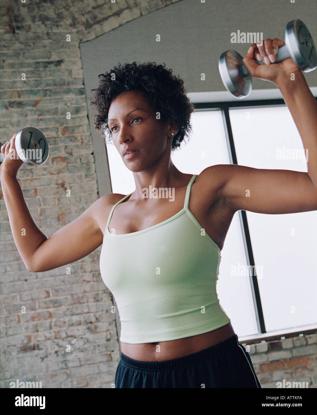 Woman working out with free weights Stock Photo - Alamy