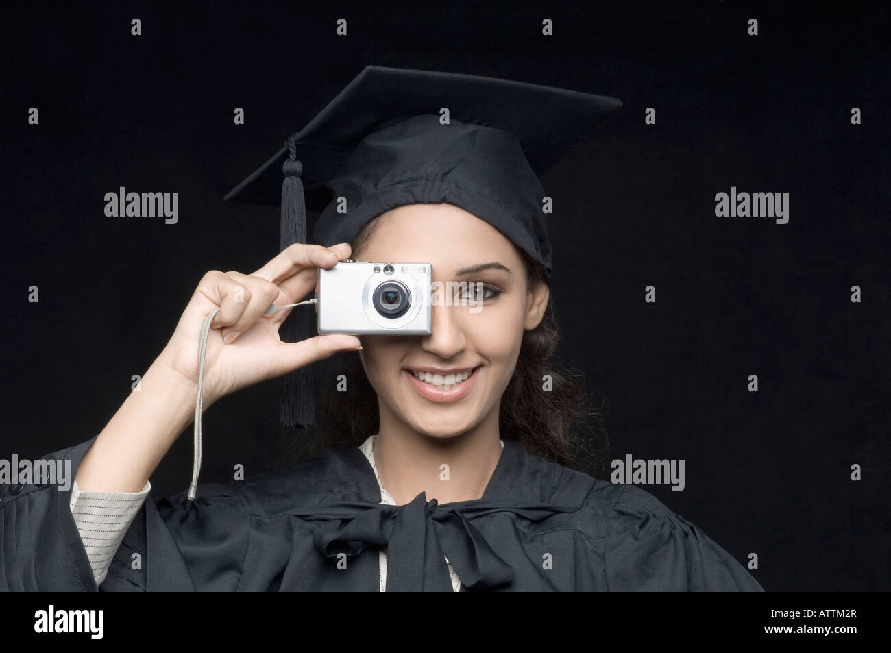 Portrait of a young female graduate taking a picture Stock Photo - Alamy