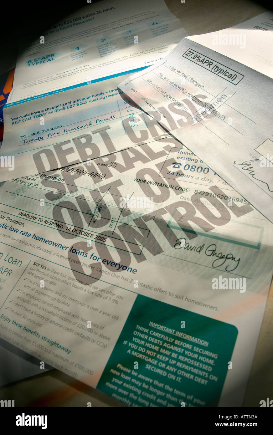 A newspaper headline about spiralling debt crisis superimposed on a ...
