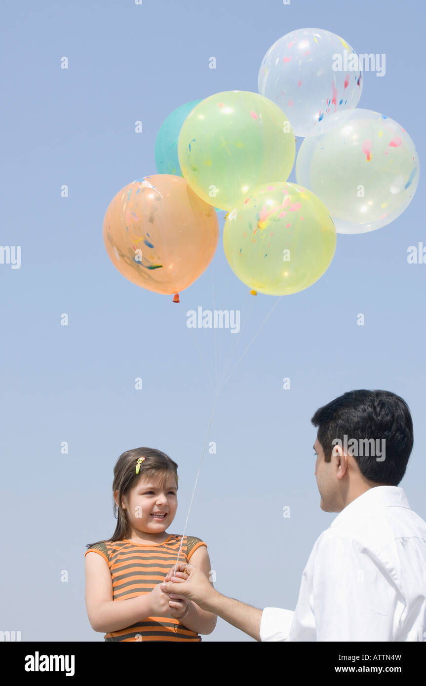 Father giving daughter balloons hi-res stock photography and images - Alamy