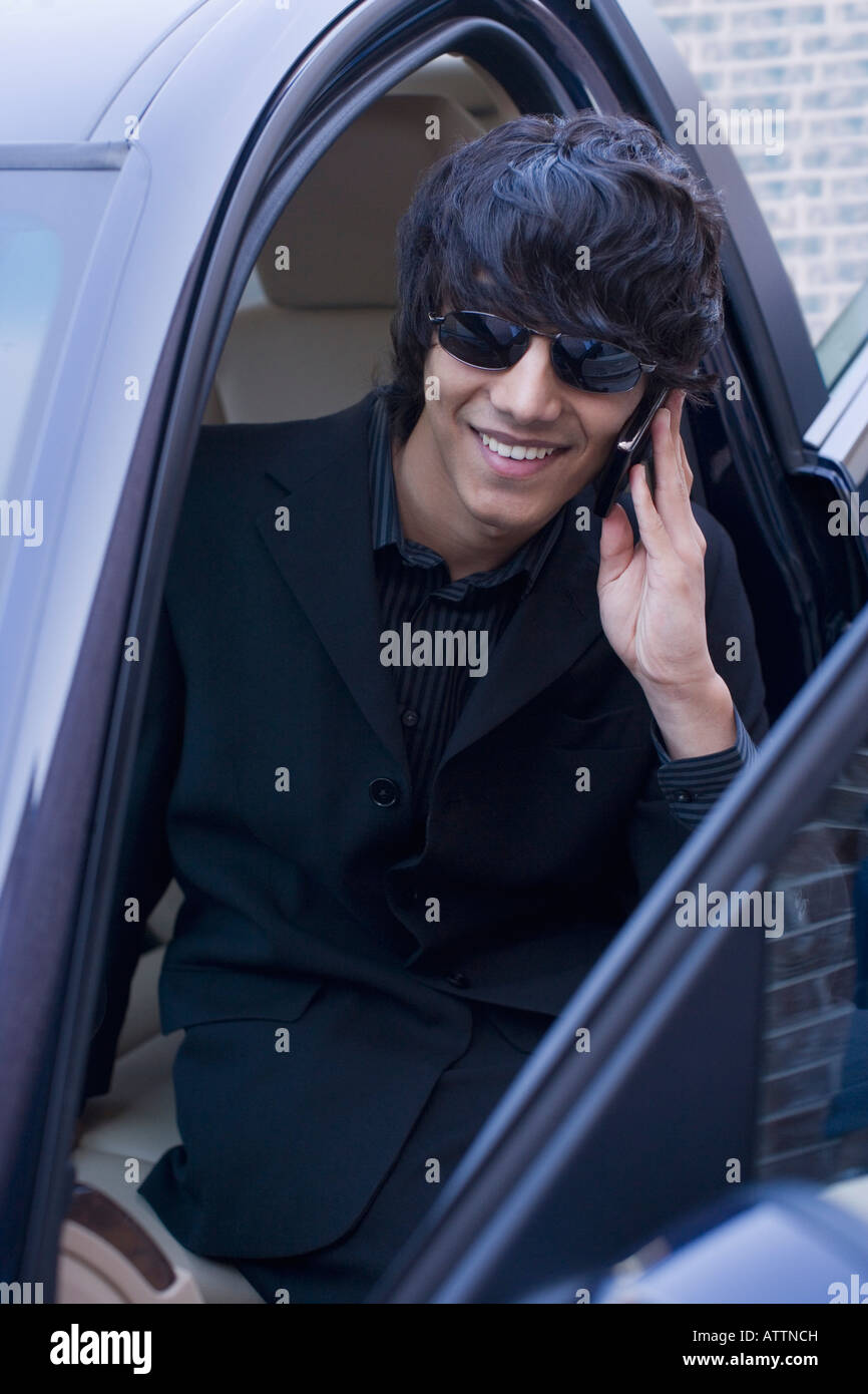Teenage boy talking on a mobile phone in a car Stock Photo - Alamy