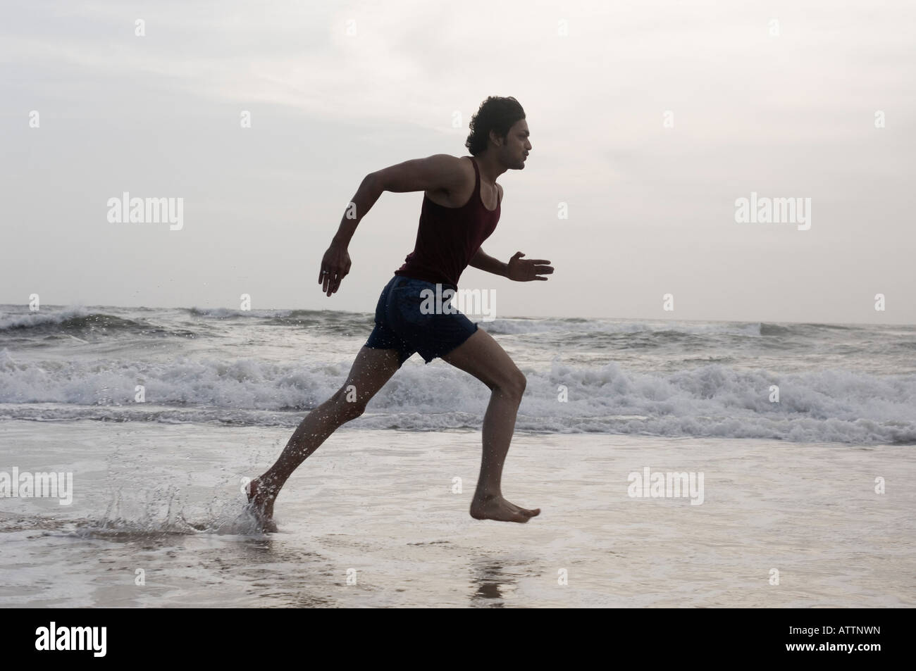 Young man running on beach asian alone hi-res stock photography and ...