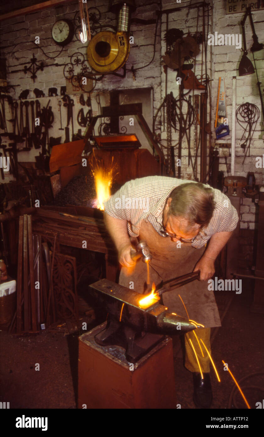 Blacksmith hammering in a workshop Stock Photo - Alamy