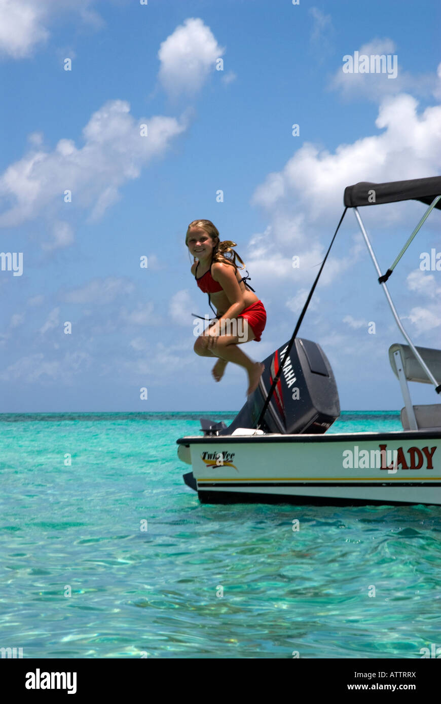 Girl jumping off of boat Rose Island Bahamas Stock Photo - Alamy