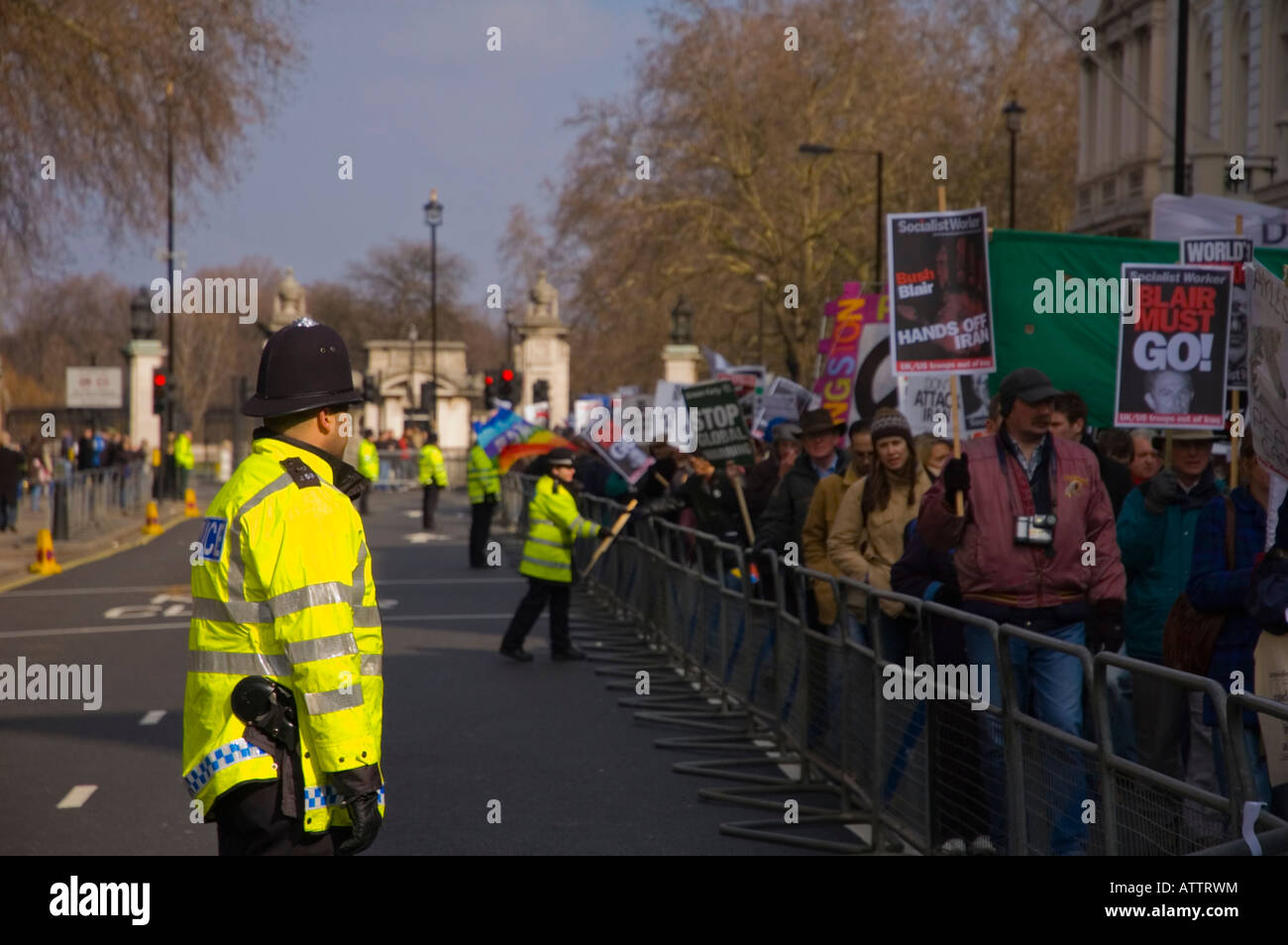 A policeman watching a anti war march in central London England UK ...