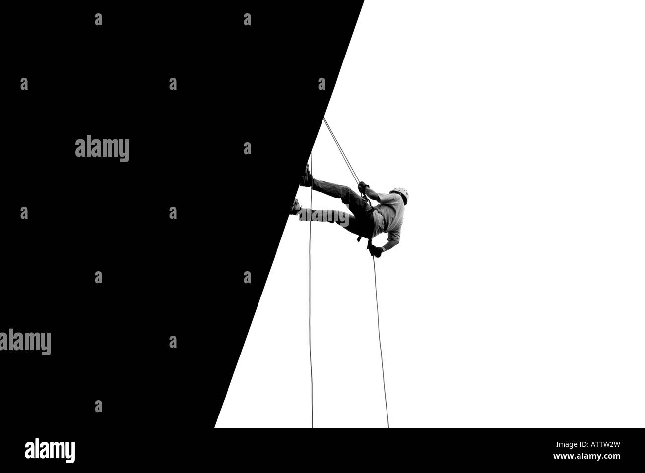 Man abseiling black and white image Stock Photo - Alamy