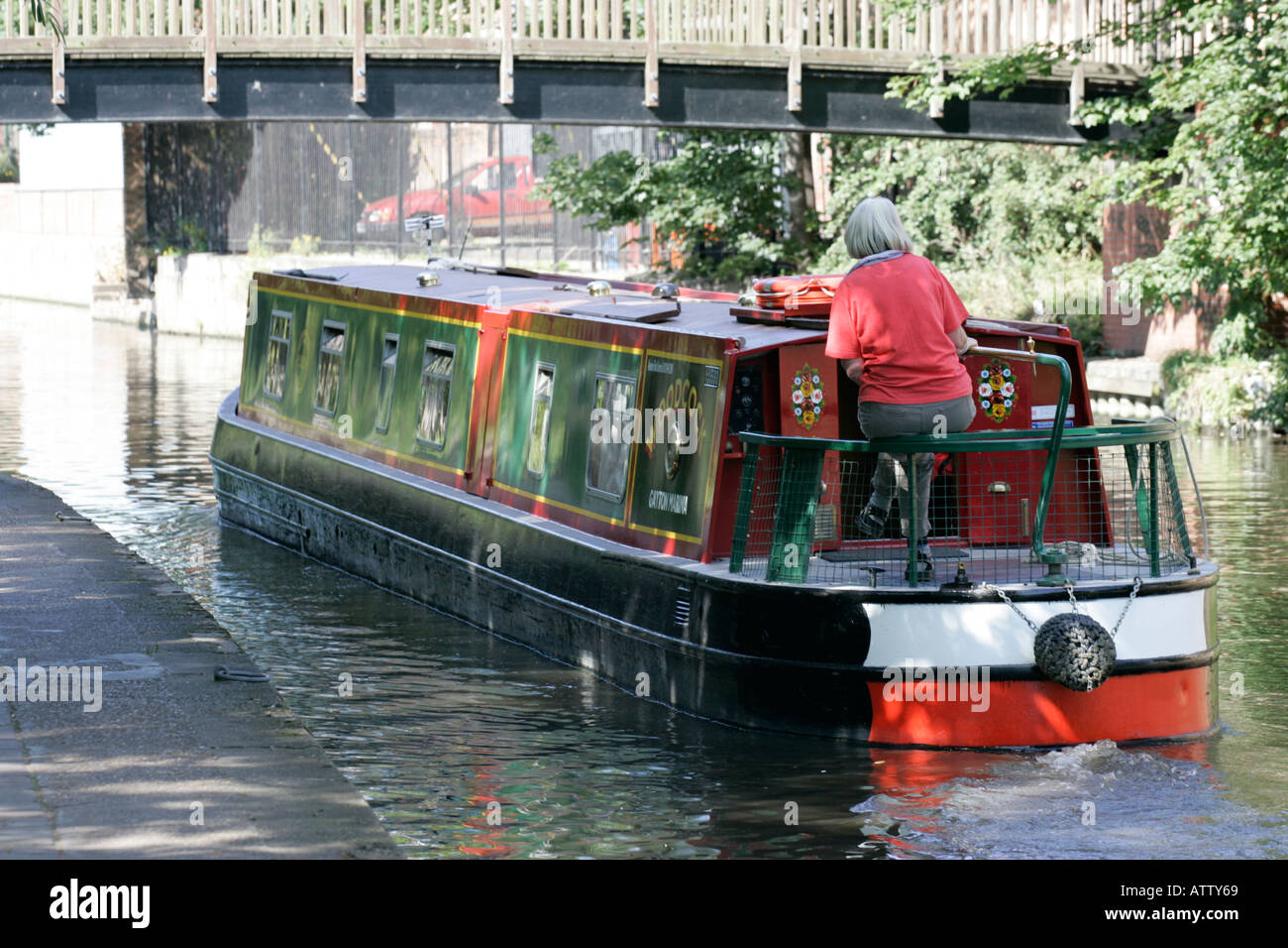 narrowboat on nottingham canal with tow path and footbridge from rear ...