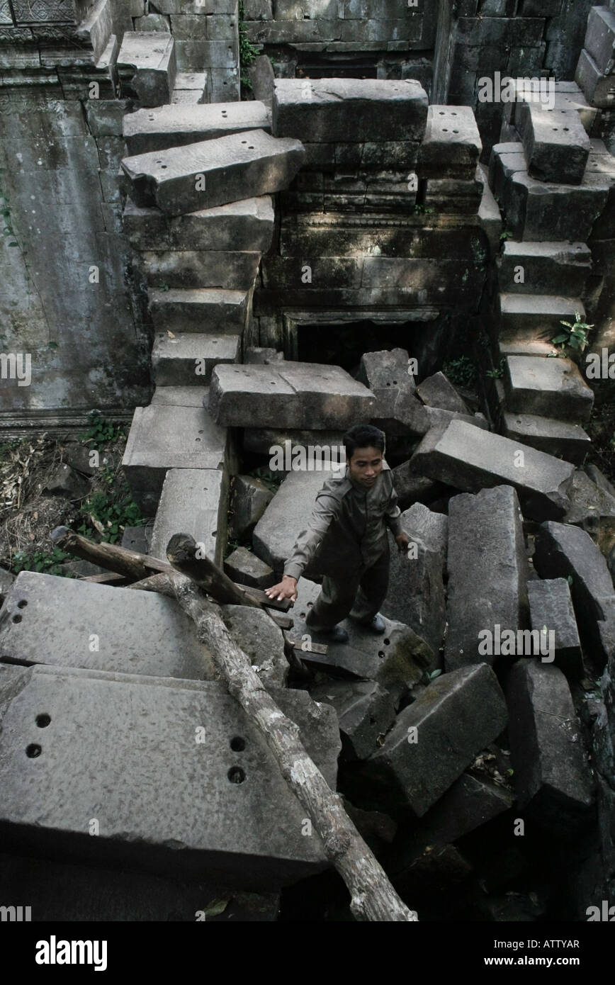 Haphazard piles of stone blocks lie where they fell at Beng Mealea. In ...