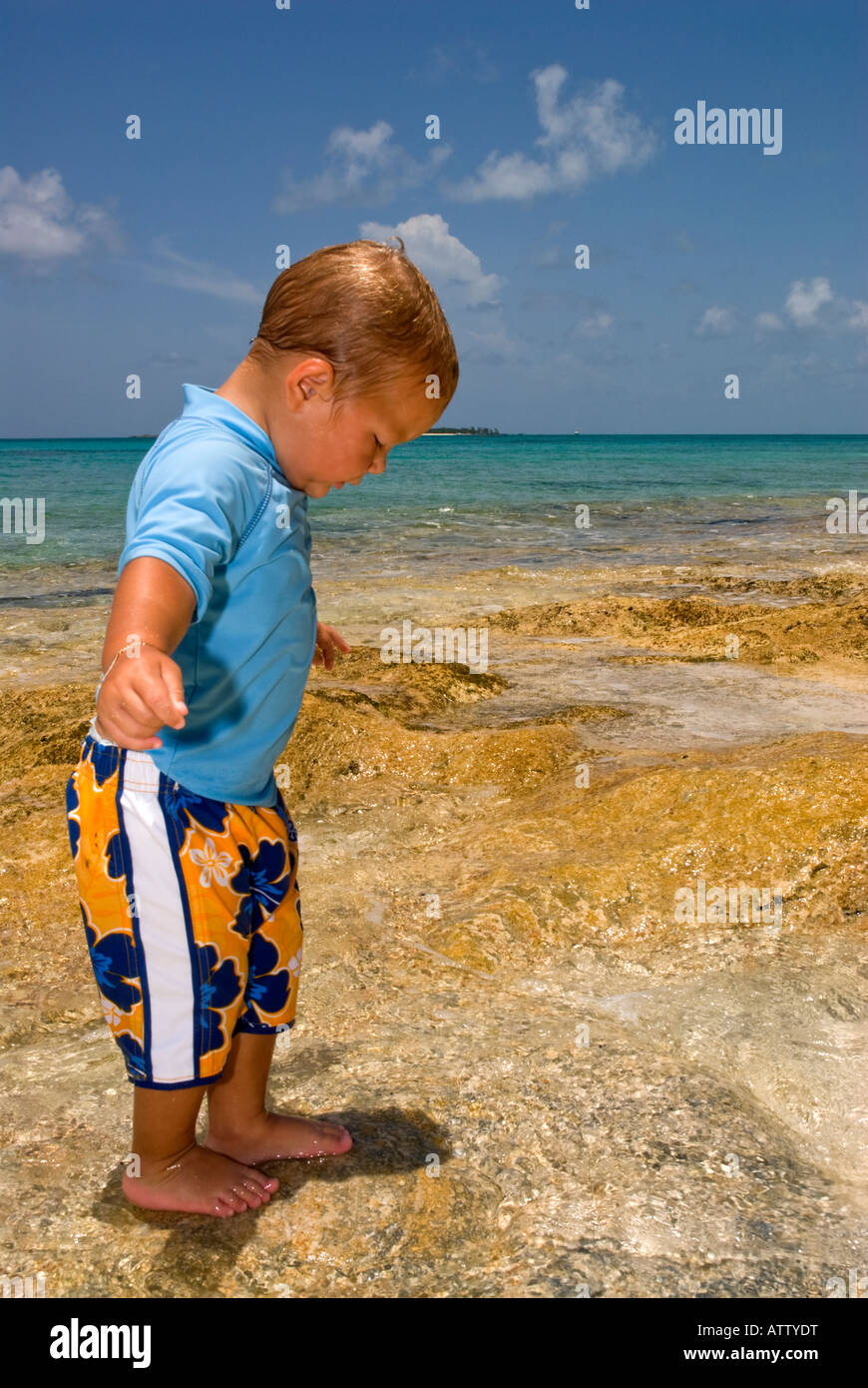 Little boy playing on rocks - Rose Island, Bahamas Stock Photo - Alamy