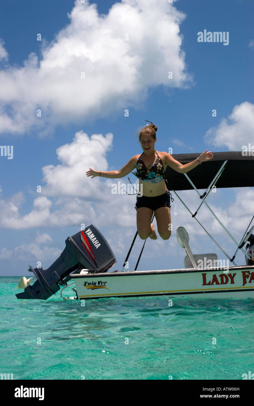 Girl jumping off of boat Rose Island Bahamas Stock Photo - Alamy