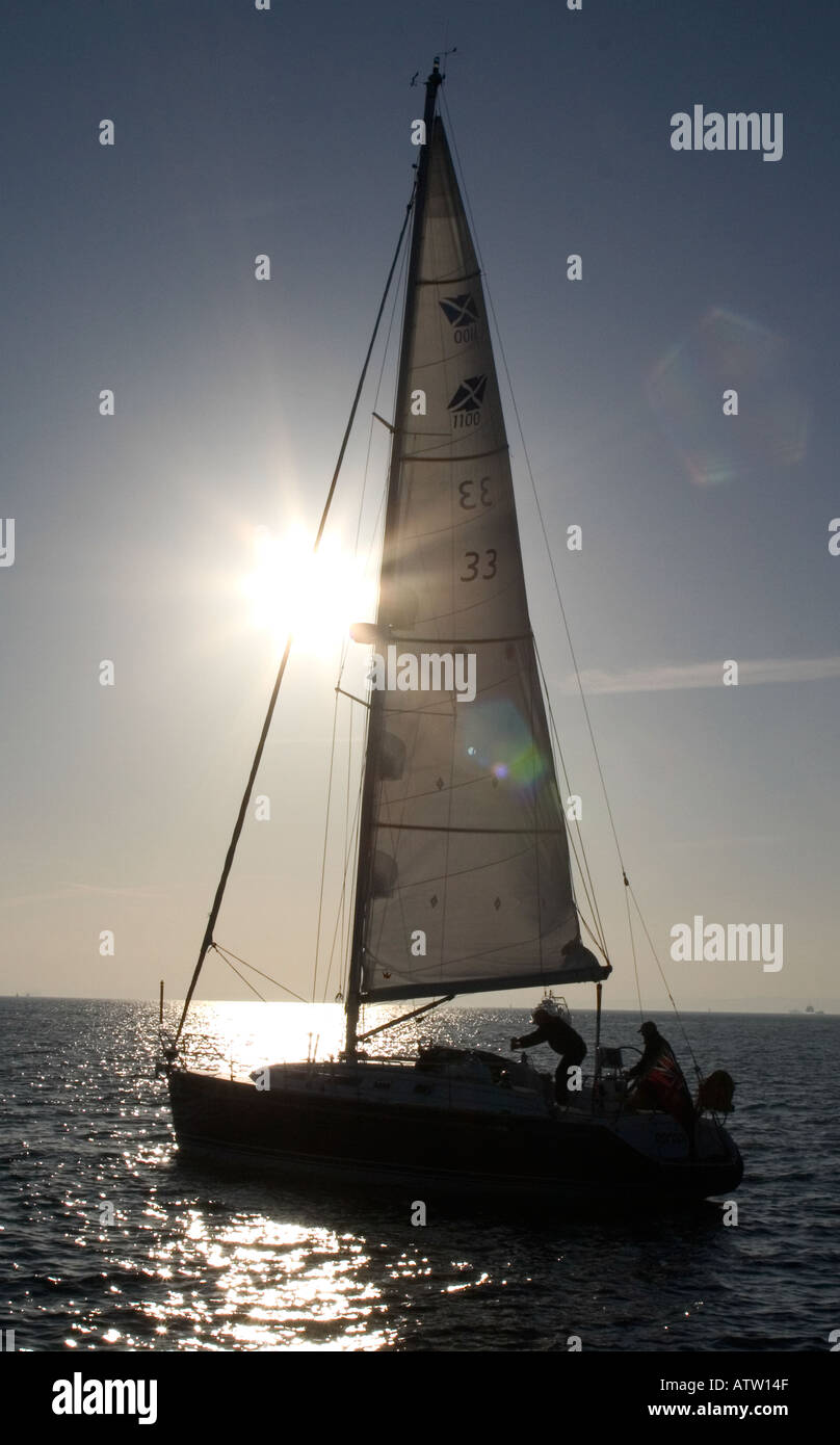 Yacht with sun in sail Stock Photo - Alamy