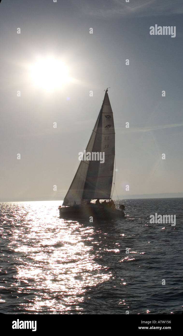 Yacht with sun behind Stock Photo - Alamy