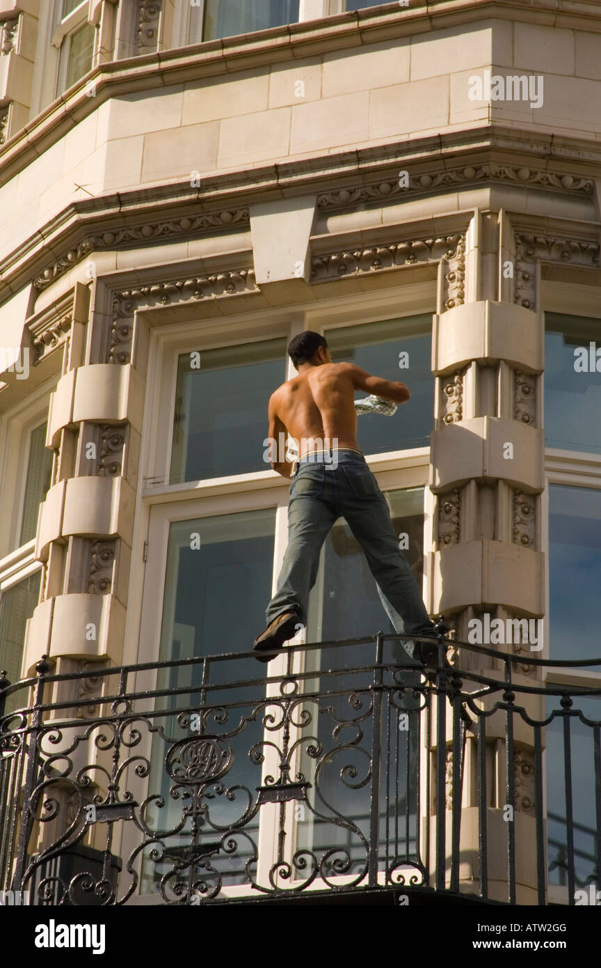 Man washing windows in Mayfair London without any safety precautions ...